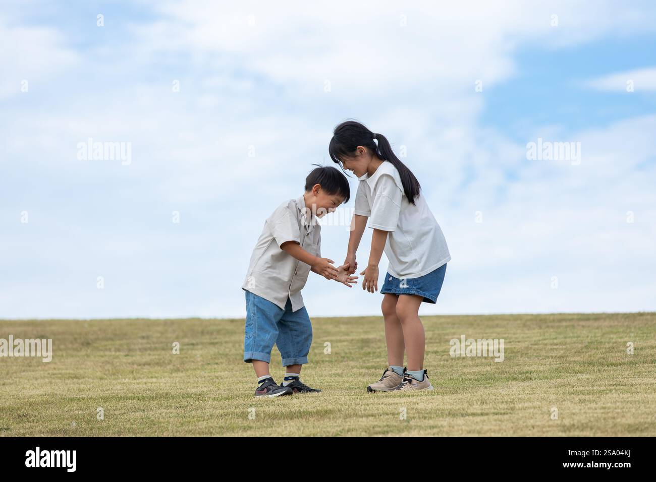 Children holding hands and playing together Stock Photo - Alamy