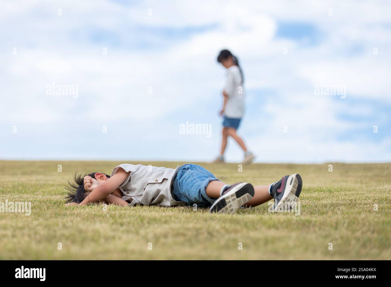 Child rolling on lawn Stock Photo - Alamy