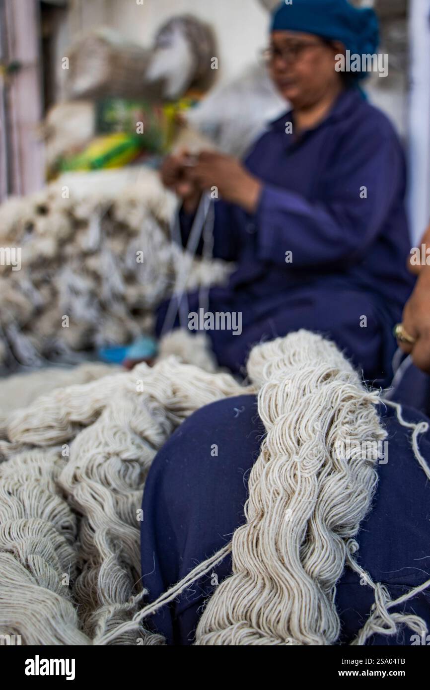 Carpet Factory worker spinning yarn in Bouddha, Kathmandu, Nepal Stock ...