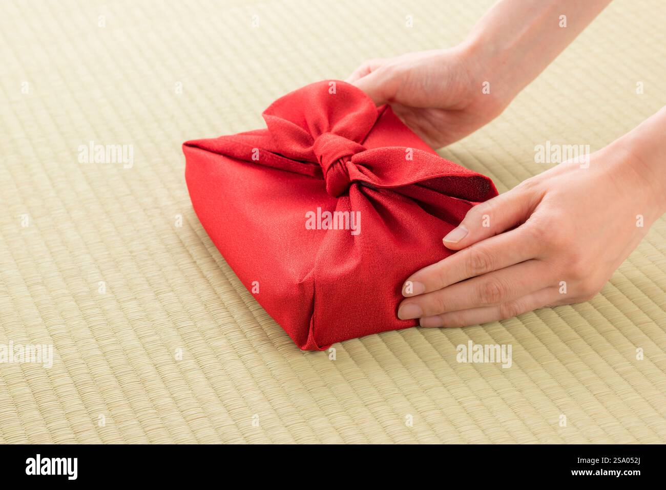 Woman's hand handing over a bath-wrapped souvenir Stock Photo - Alamy