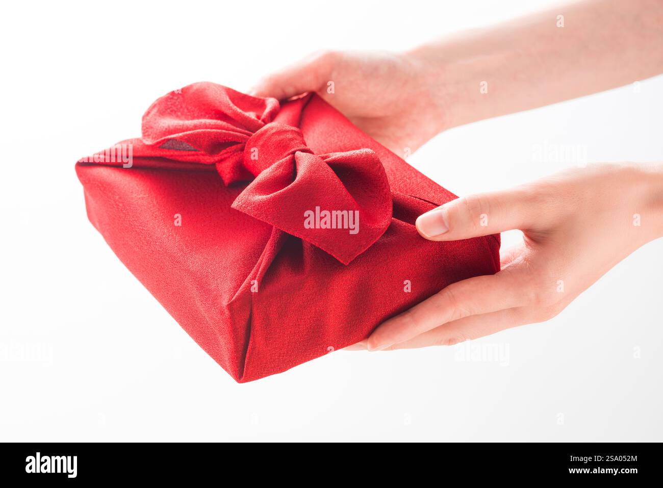 Woman's hand handing over a bath-wrapped souvenir Stock Photo - Alamy