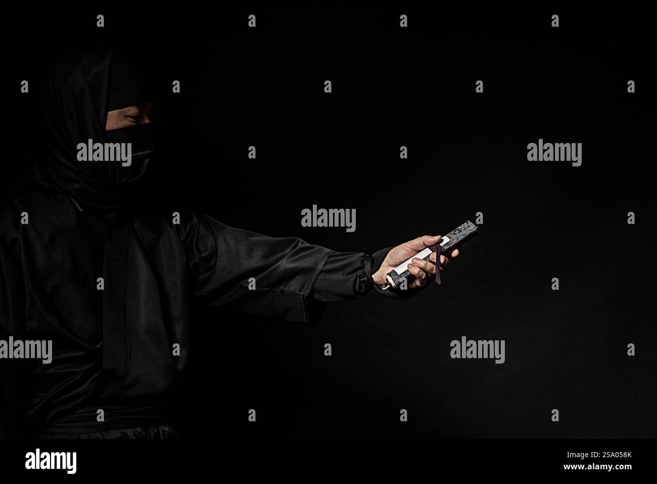 Ninja holding scroll in hand Stock Photo - Alamy