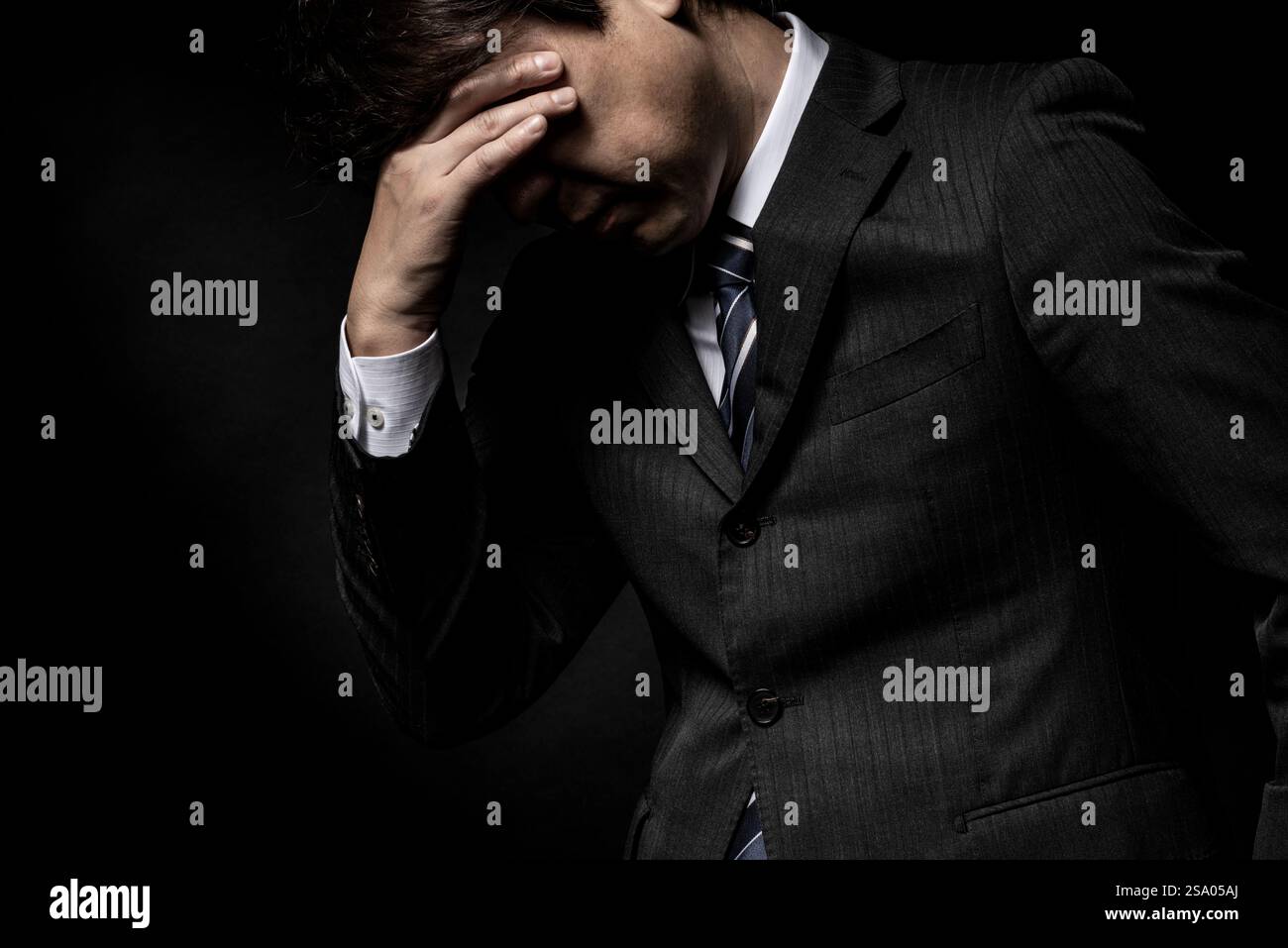 Distressed man holding his head Stock Photo - Alamy