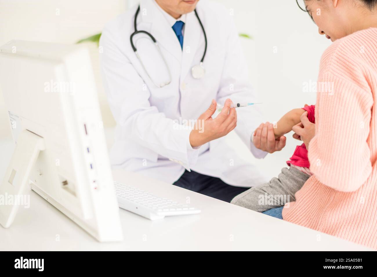 Child receiving injection in hi-res stock photography and images - Alamy