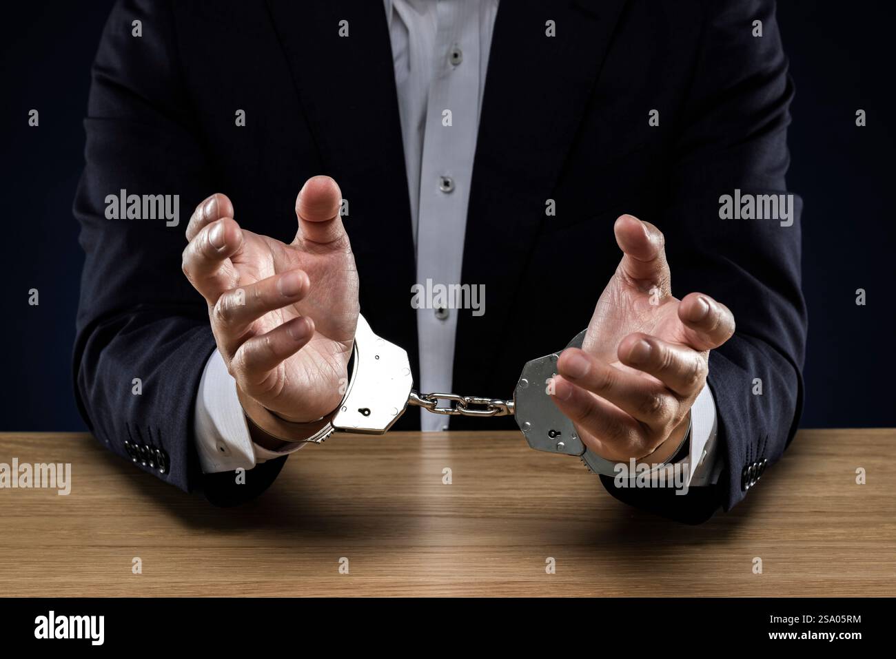 Handcuffed male hand Stock Photo - Alamy