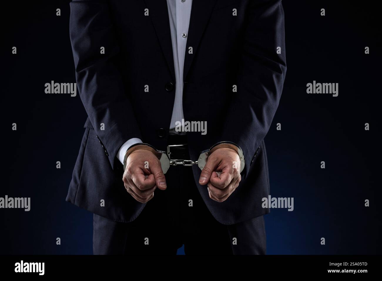 Handcuffs and male hand Stock Photo - Alamy