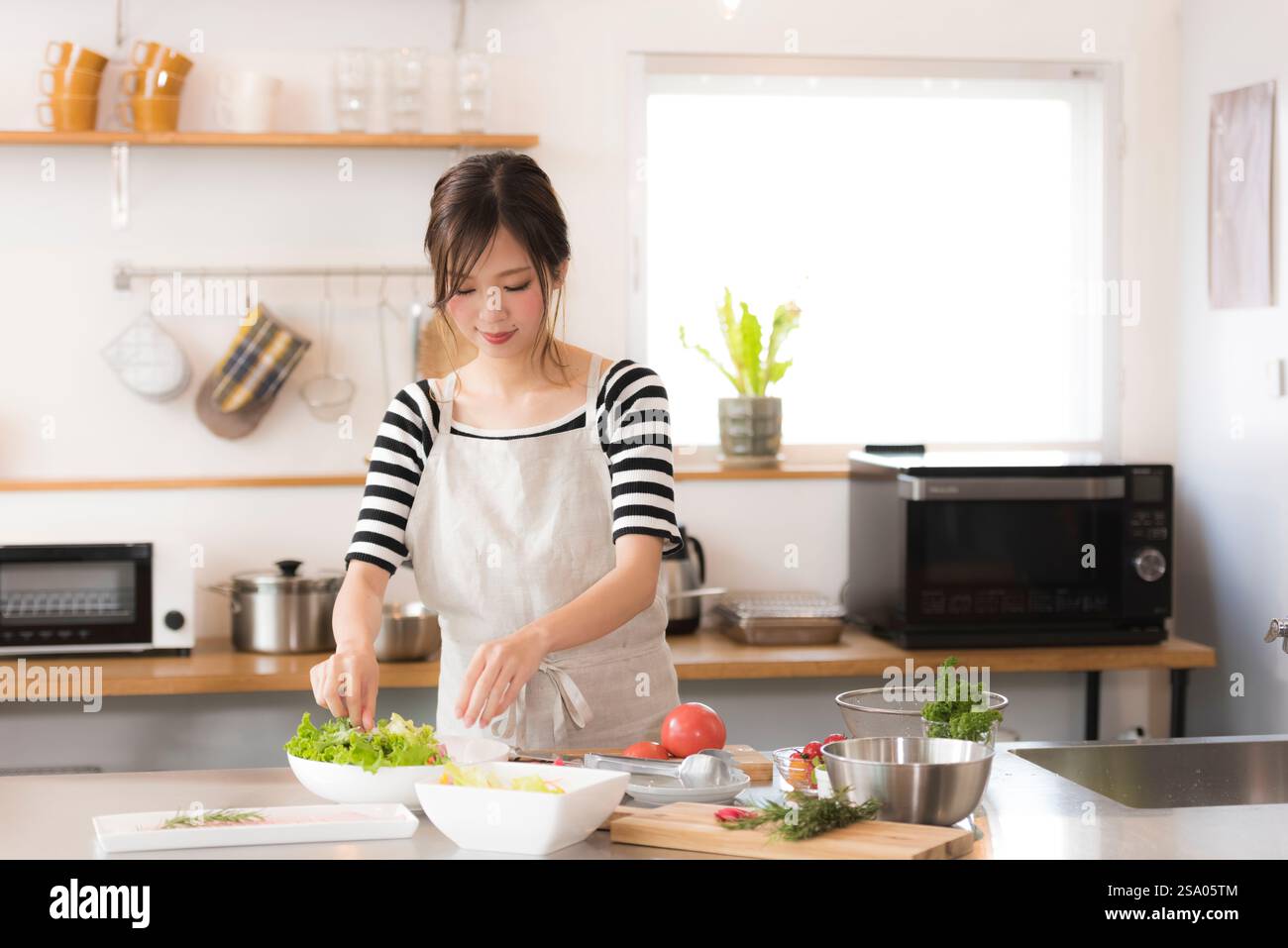 Woman cooking in kitchen Stock Photo - Alamy
