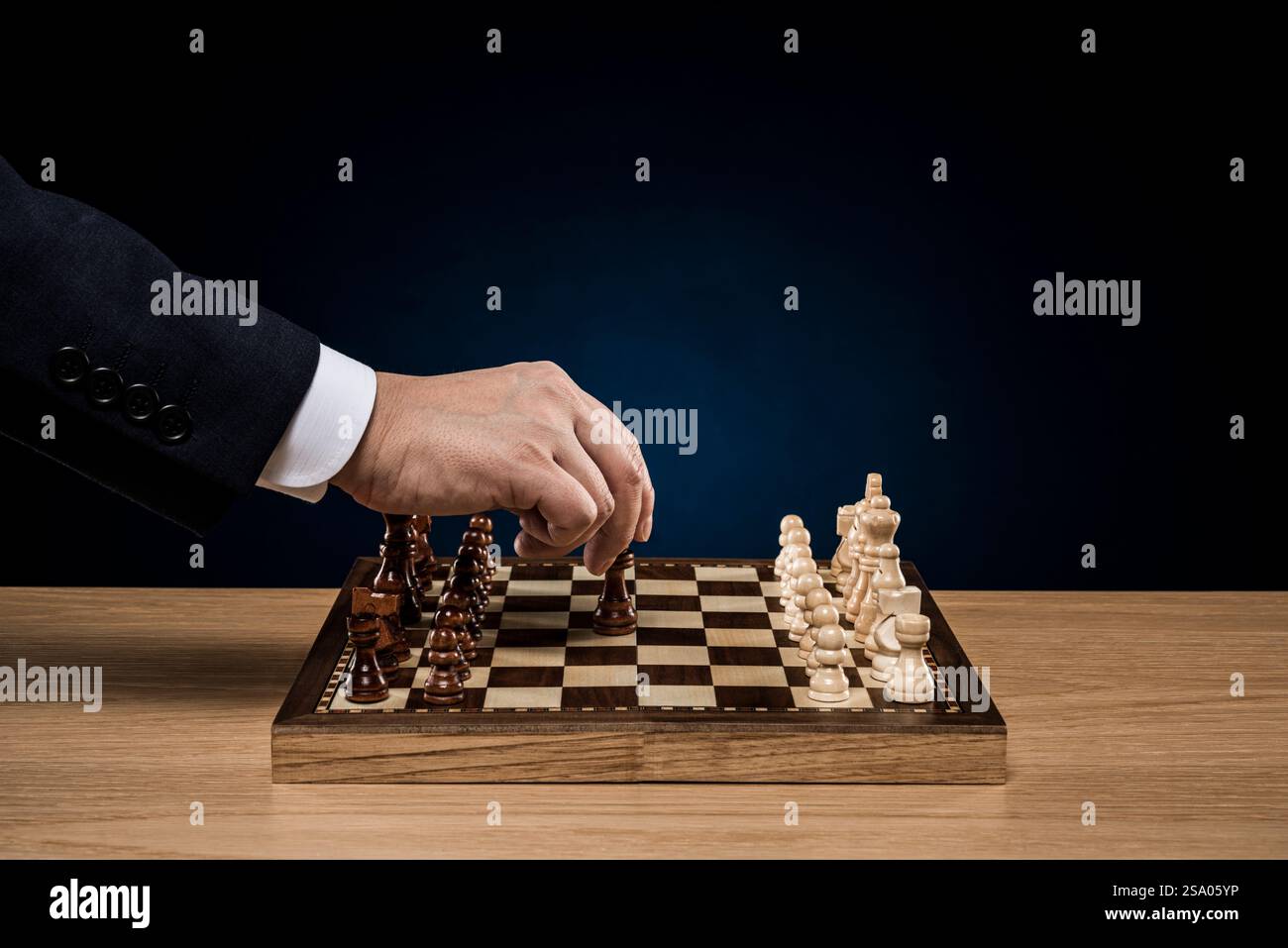Man in suit playing chess in hand Stock Photo - Alamy