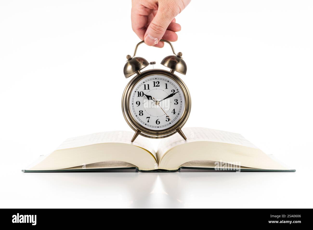 Open book and clock Hand Stock Photo - Alamy