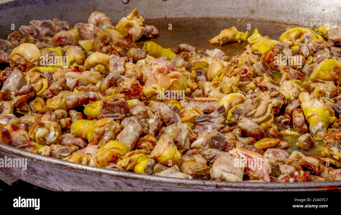 meat frying in a large paella pan for feast outside sagrada familia ...
