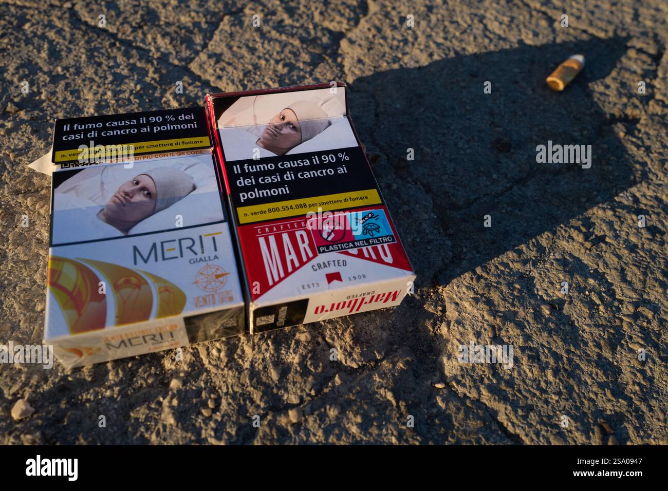 Discarded Cigarette Packs Highlight Lung Cancer Warning Stock Photo - Alamy