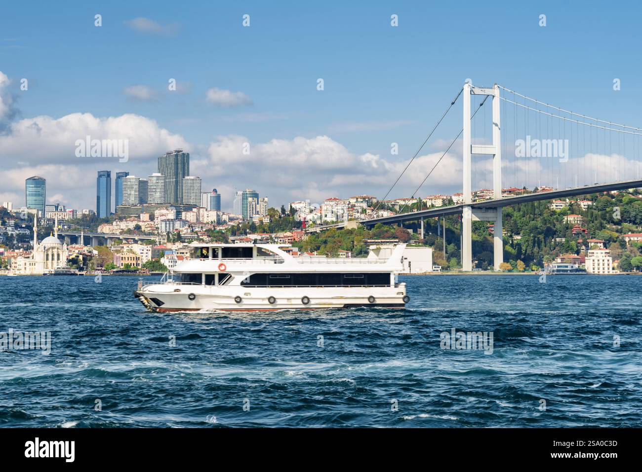 Tourist boat crossing the Bosporus. View of the Bosphorus Bridge Stock ...