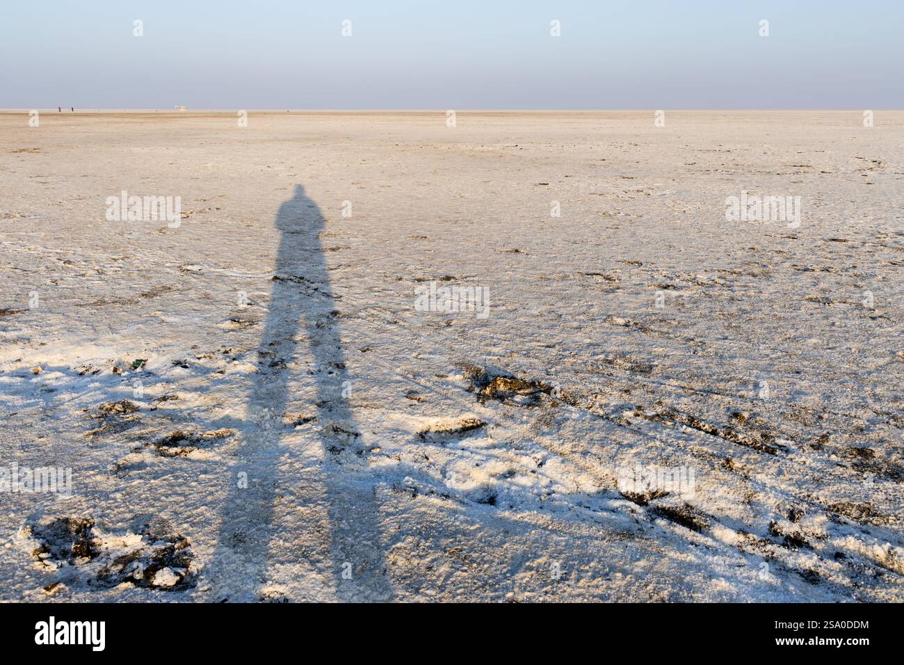 white salt flats desert with man shadow at morning image is taken at ...