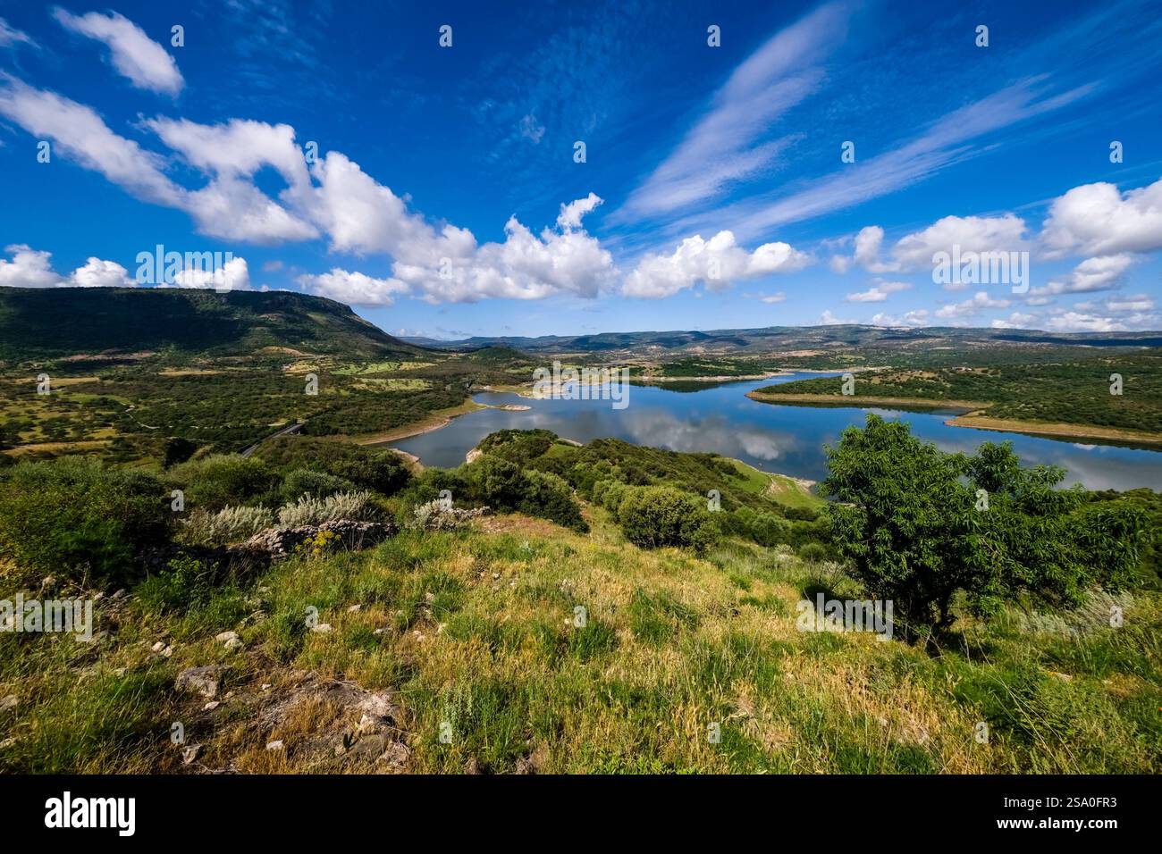 Aerial view of the lake Lago dell Alto Temo, surrounded by agricultural ...