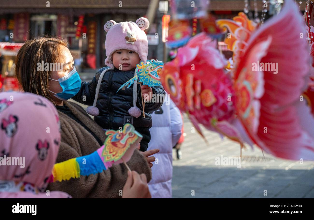 Beijing, China. 28th Jan, 2025. Tourists visit the Moshikou Historical ...