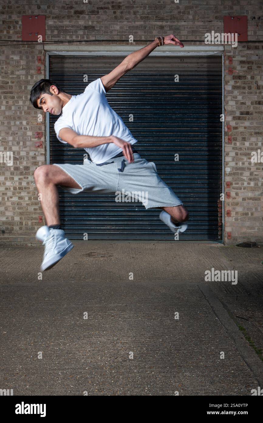 A series of images of dancers creating abstract shapes while frozen in midair in an urban ...