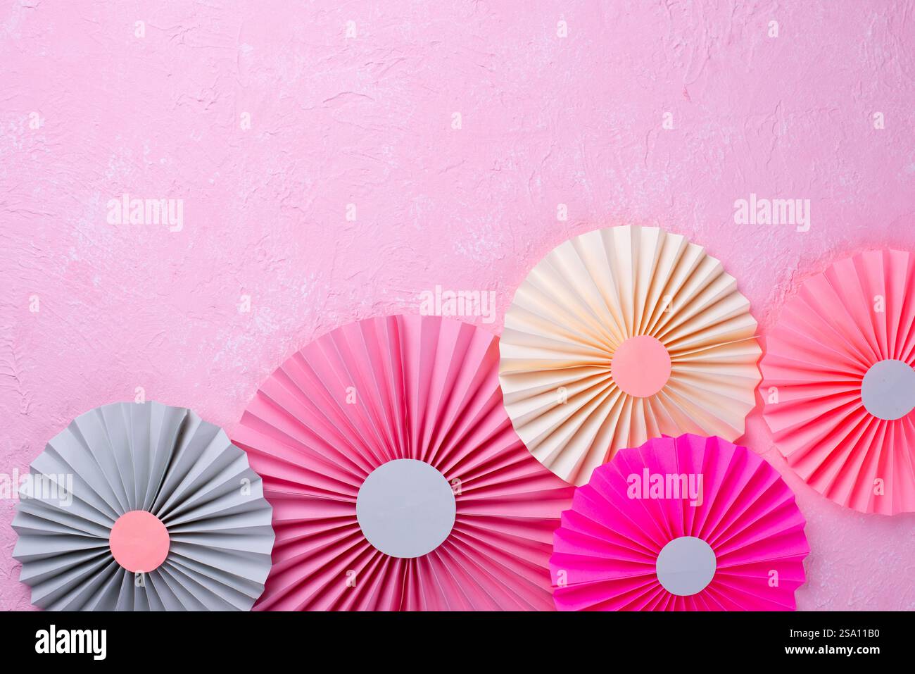 Pink paper fans fot birthday party Stock Photo - Alamy