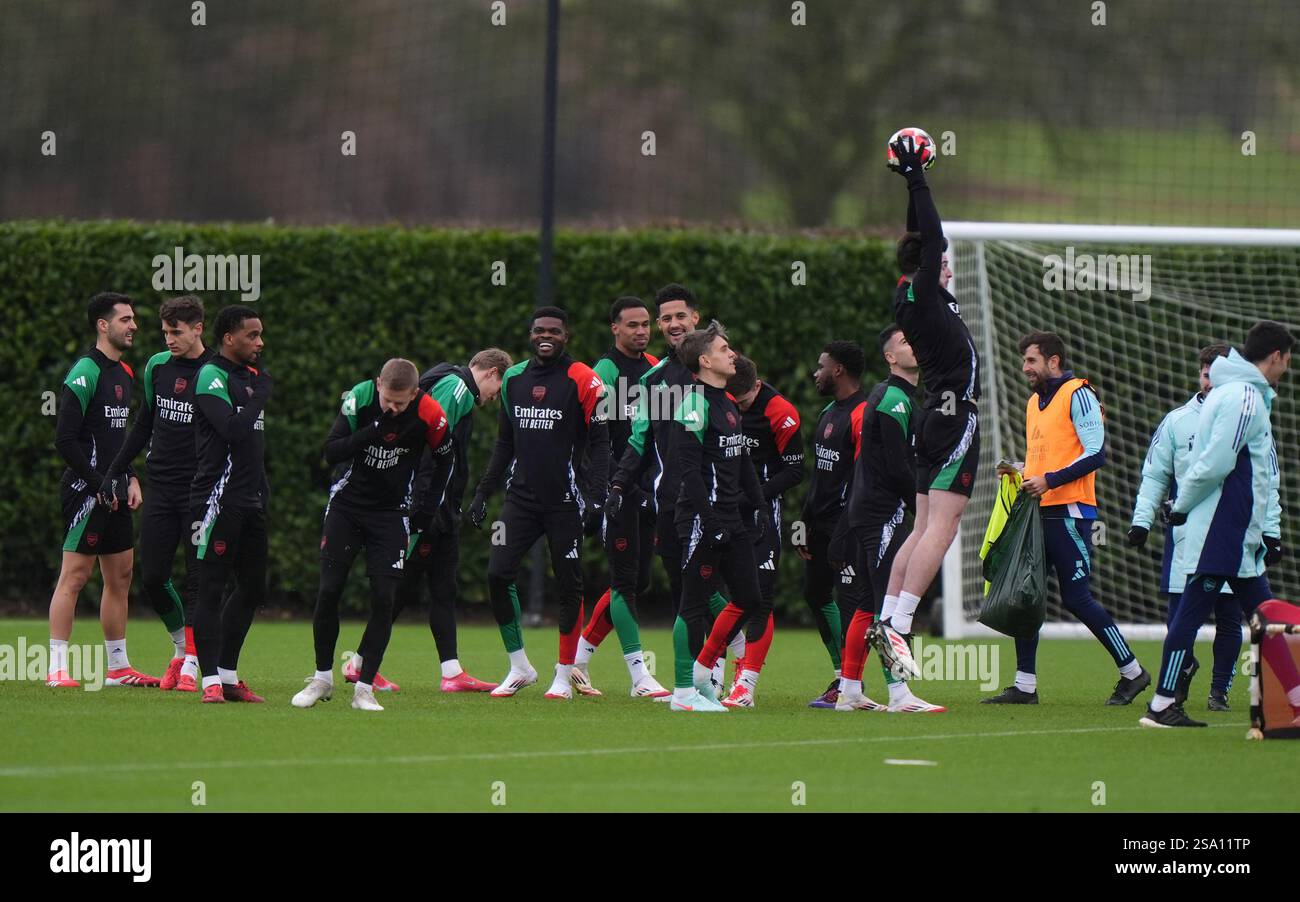 Arsenal's Declan Rice catches a high ball as team-mates look on during ...
