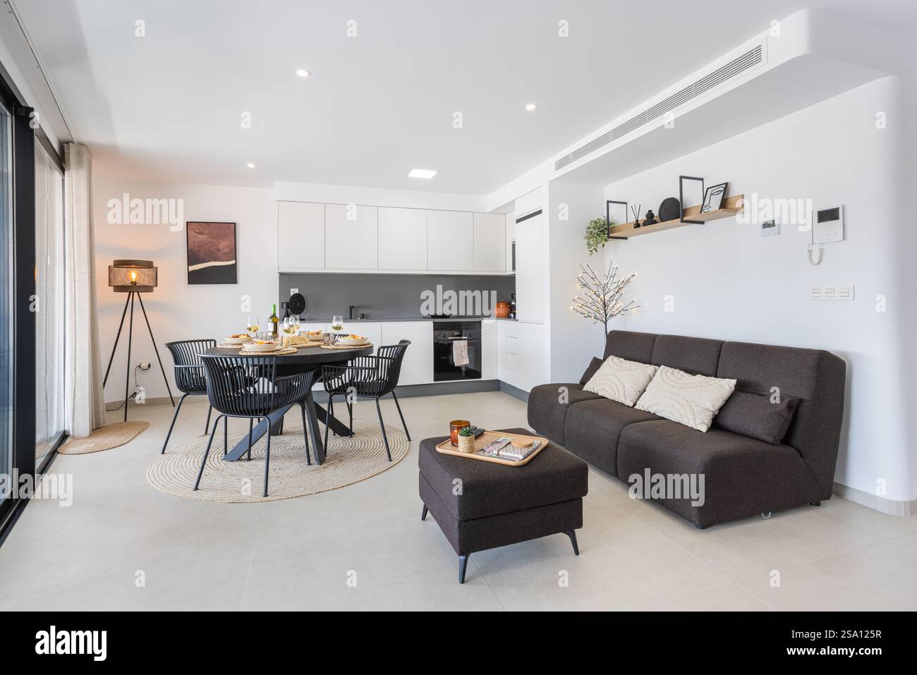 A bright and stylish open-plan living room featuring a dining table ...