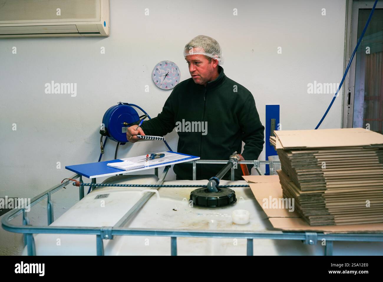 Disabled worker working in the shaping and packaging workshop. Quality ...