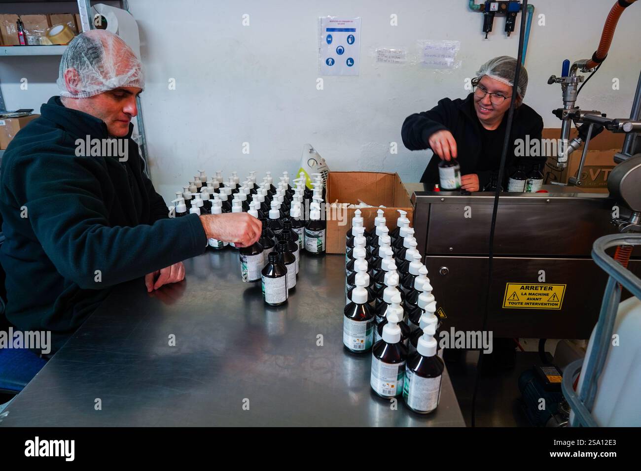 Disabled workers working in the shaping and packaging workshop. Filling ...