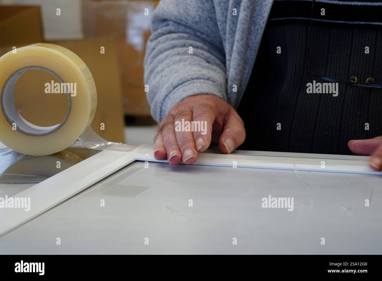 Disabled worker working in the shaping and packaging workshop. Quality ...