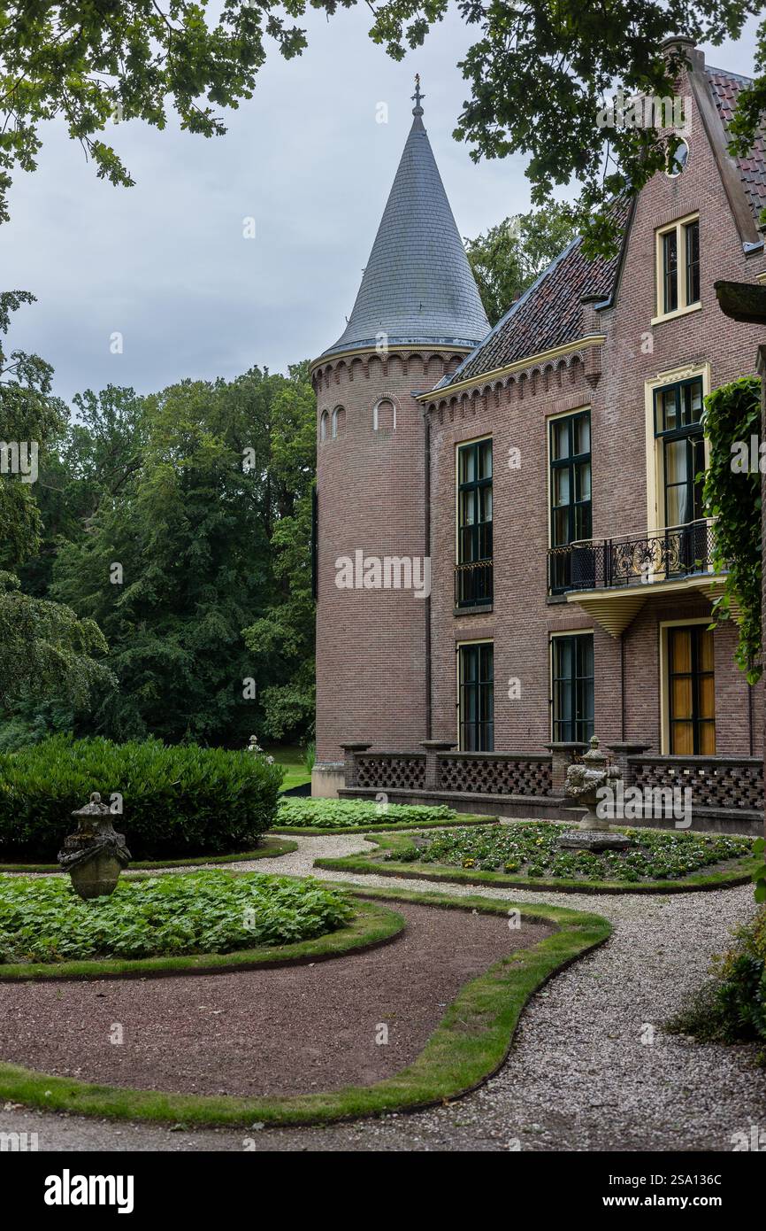A picturesque view of a historic brick mansion with a round tower ...