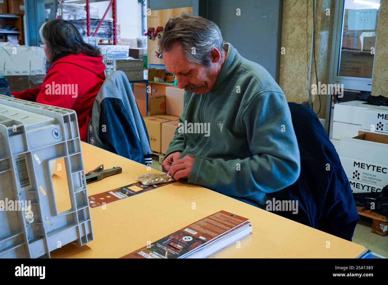 Disabled worker working in the ESAT product packaging workshop ...