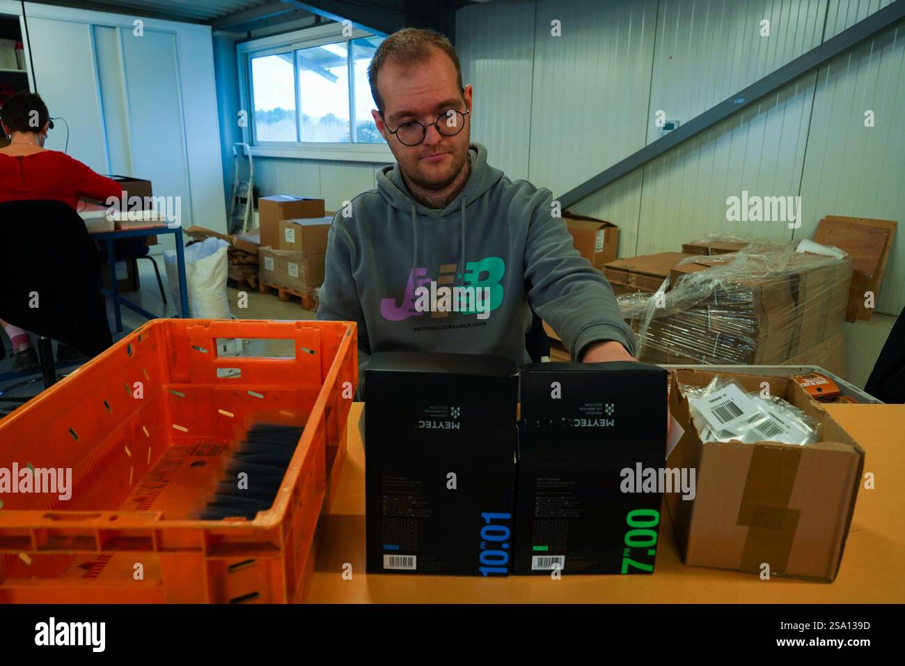 Disabled worker working in the ESAT product packaging workshop ...