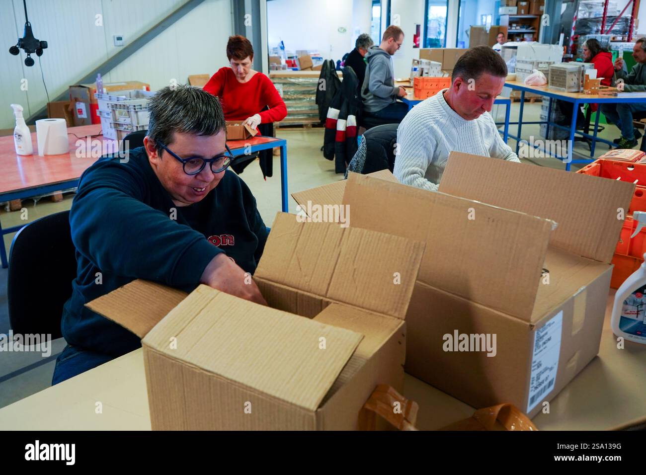 Disabled worker working in the ESAT product packaging workshop . Making ...
