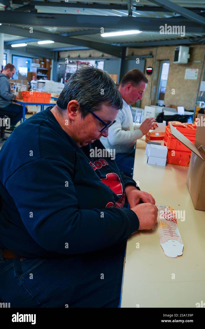 Disabled worker working in the ESAT product packaging workshop . Making ...
