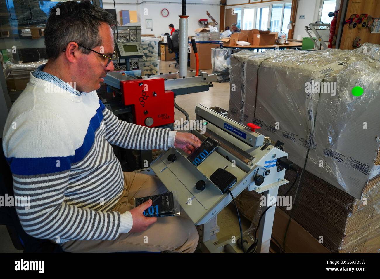 Disabled worker working in the ESAT product packaging workshop ...