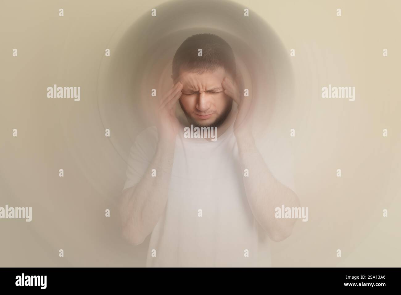 Man suffering from headache and dizziness on dark beige background ...