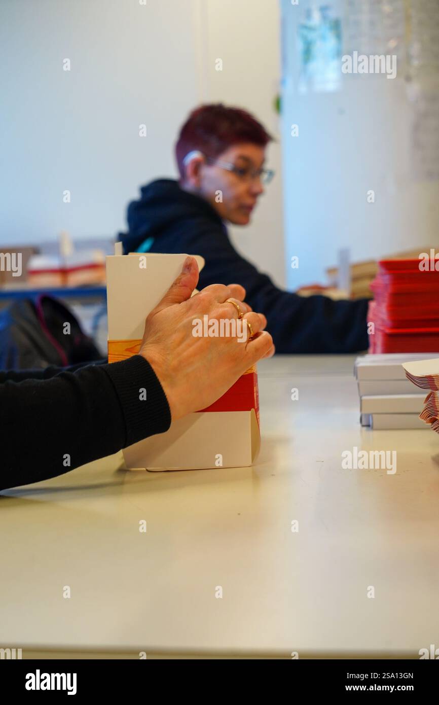 Disabled worker working in the ESAT product packaging workshop ...