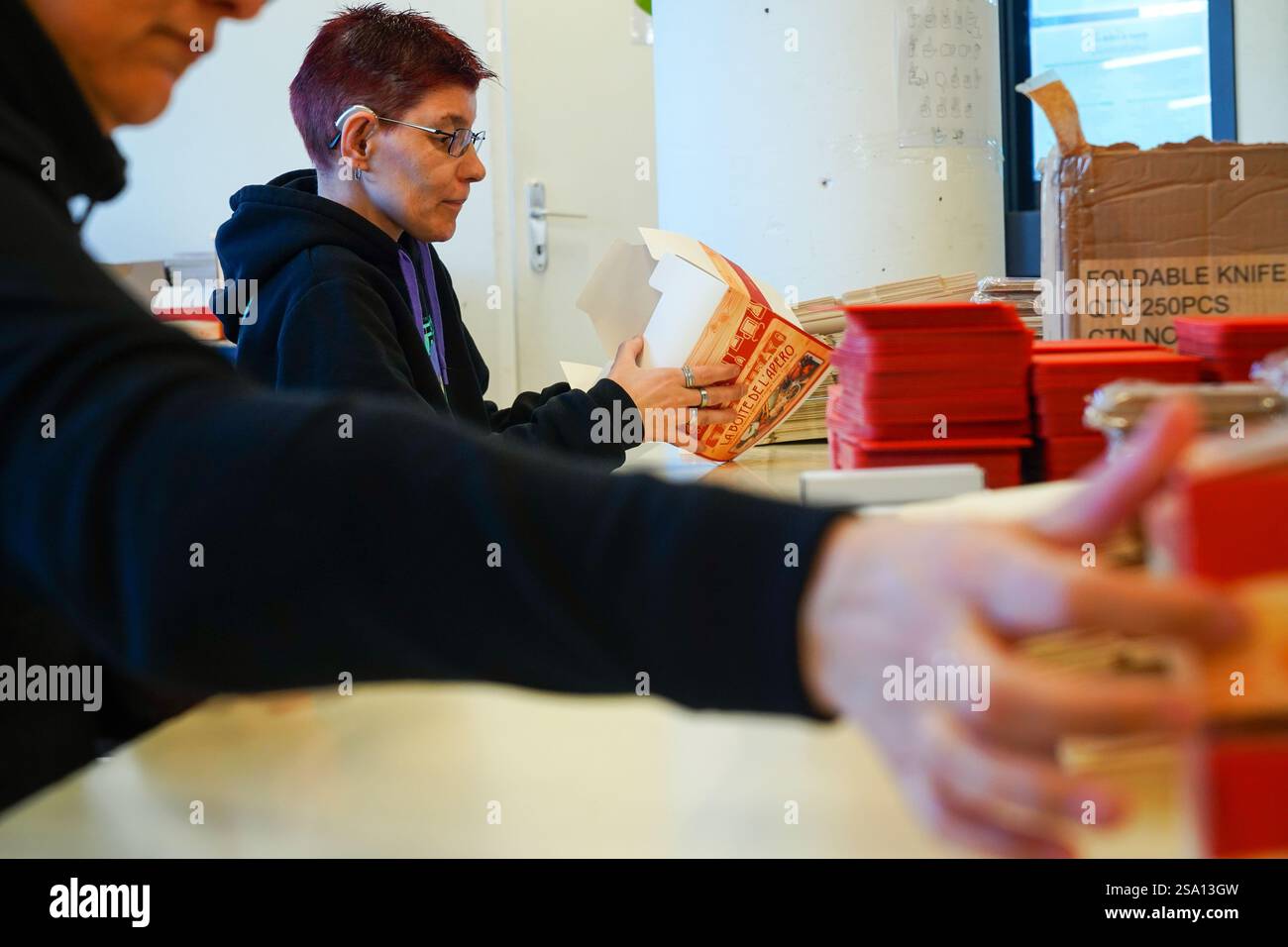 Disabled worker working in the ESAT product packaging workshop ...