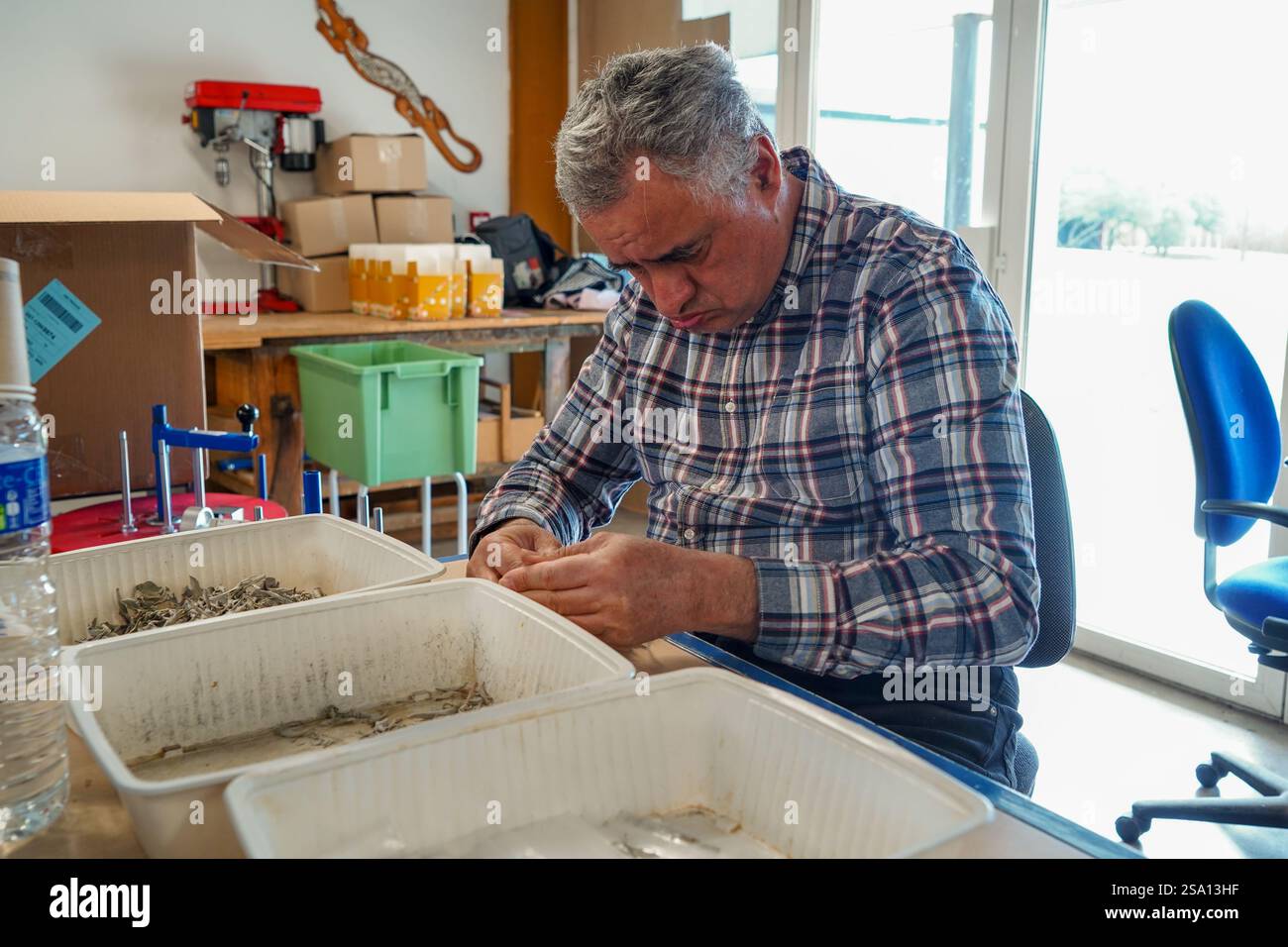 Disabled worker working in the ESAT product packaging workshop ...