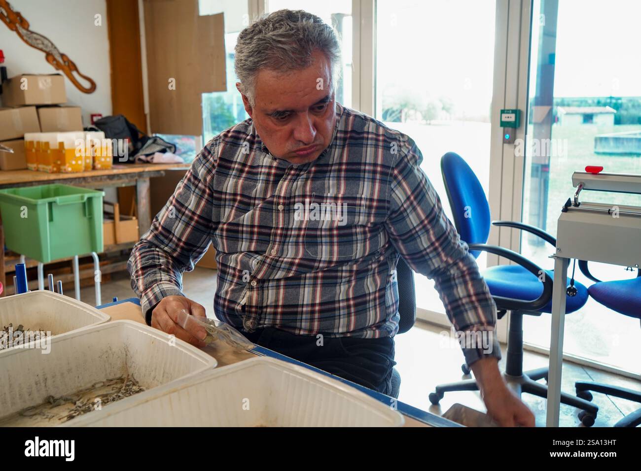 Disabled worker working in the ESAT product packaging workshop ...