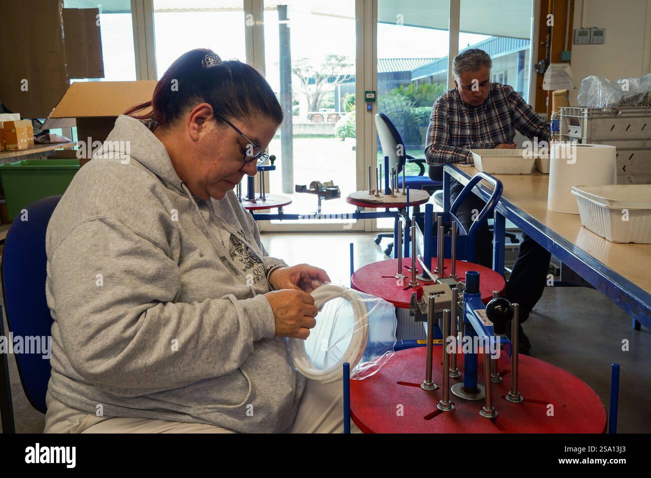 Disabled workers working in the ESAT product packaging workshop ...