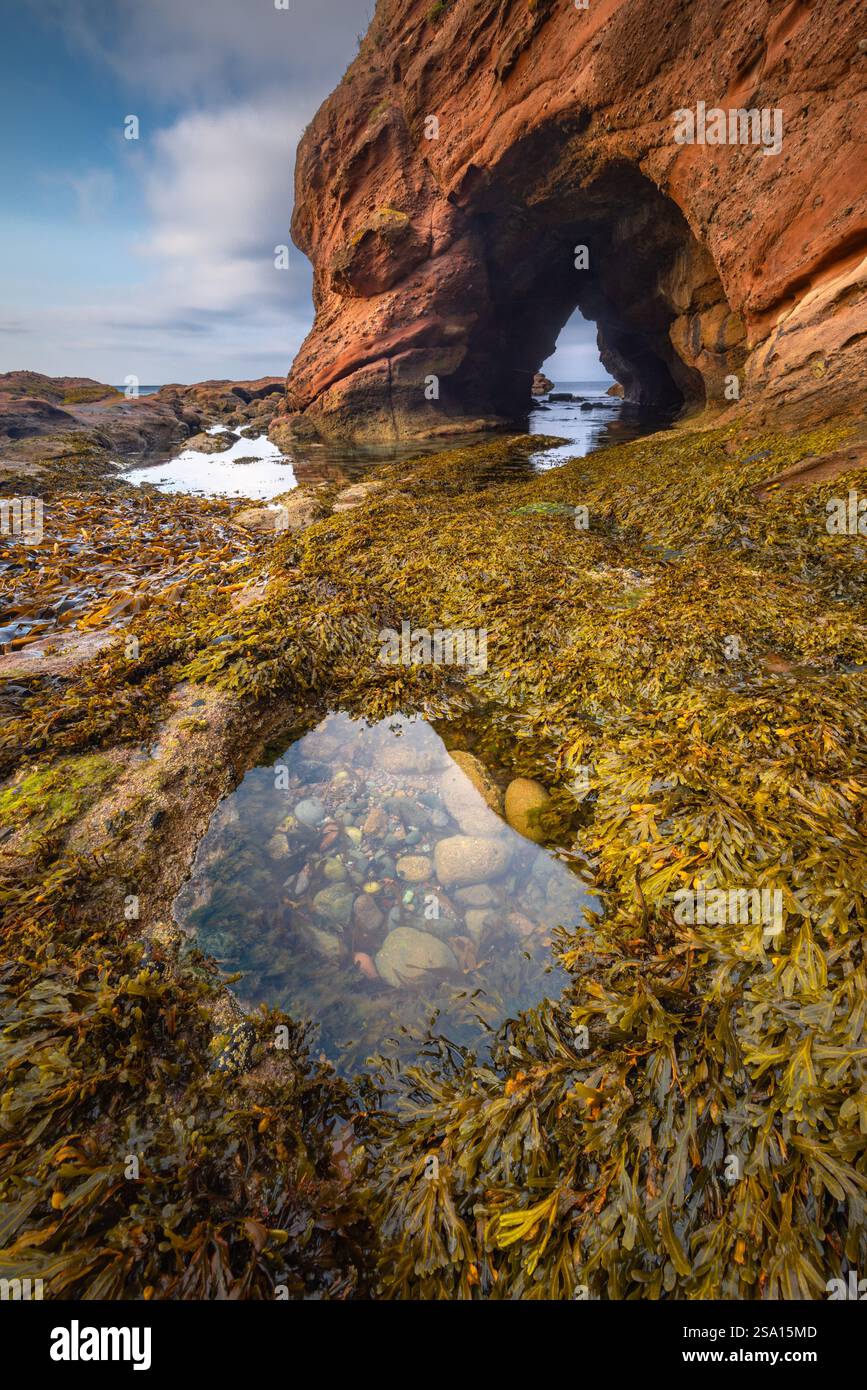 Aberdour beach has a sea arch in the cliffs carved out of the sandstone ...