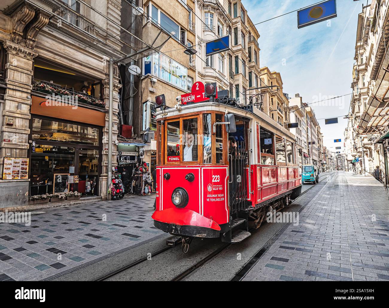 An iconic red tram travels through a historic European street ...