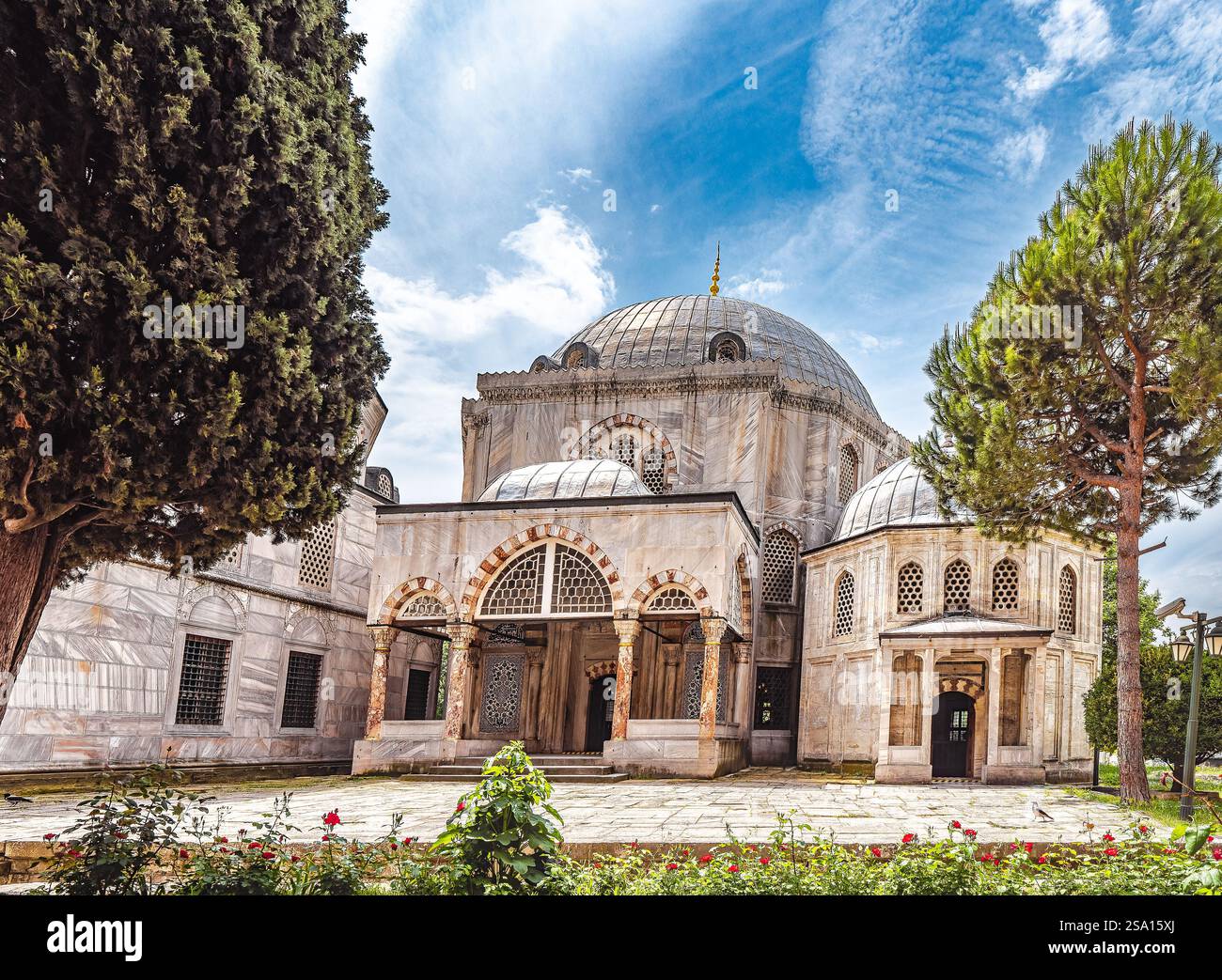 A stone mosque featuring historic architecture is surrounded by ...