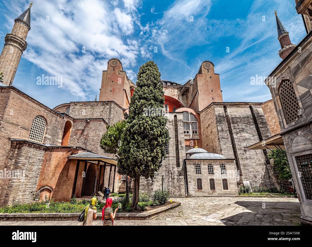 A stone mosque featuring historic architecture is surrounded by ...