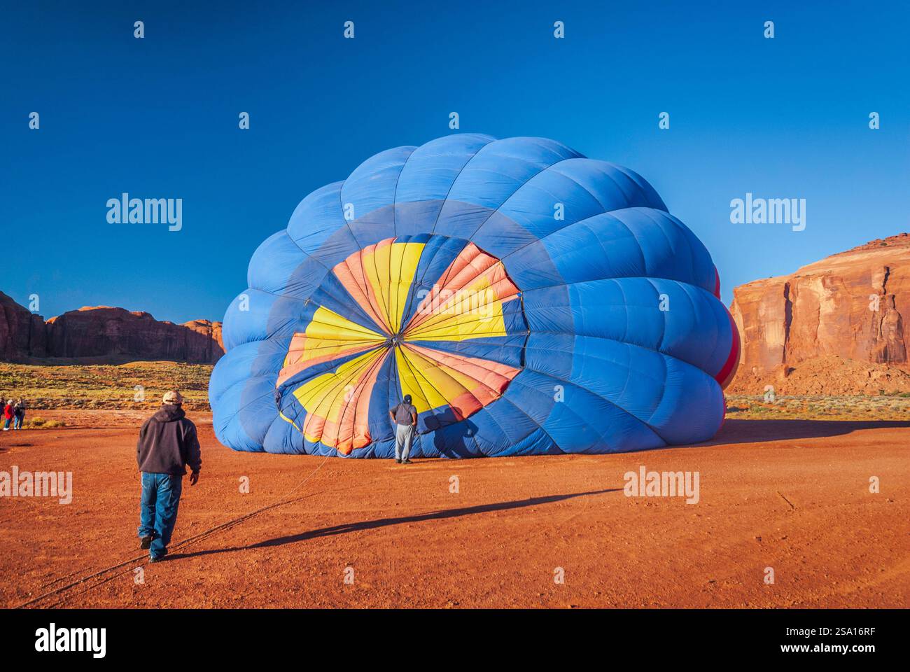 Hot air balloon getting inflated before taking off near Spearhead Mesa ...