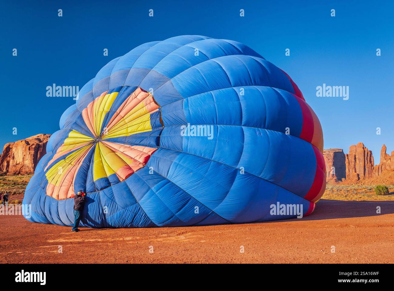 Hot air balloon getting inflated before taking off near Spearhead Mesa ...