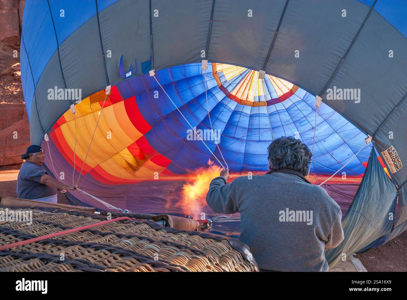 Hot air balloon getting inflated before taking off near Spearhead Mesa ...