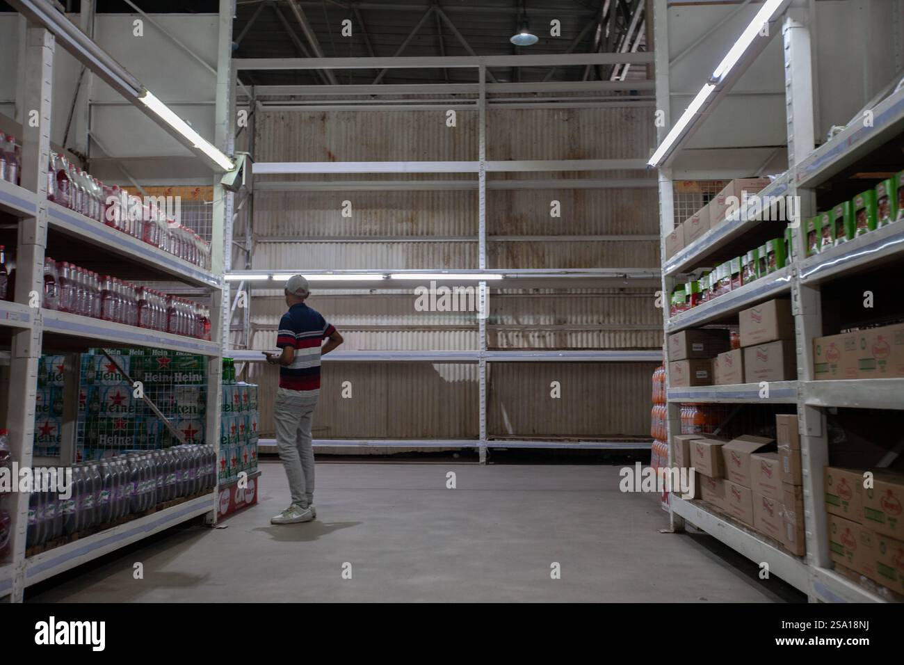 ZIMBABWE S RETAIL SECTOR FACES COLLAPSE A customer views empty shelves ...