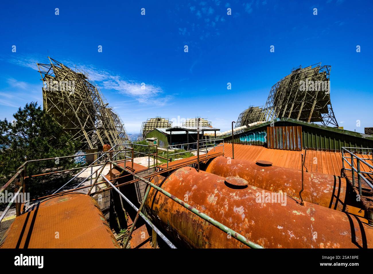Rusty tanks and large parabolic antennas of Stazione Troposcatter USAF ...