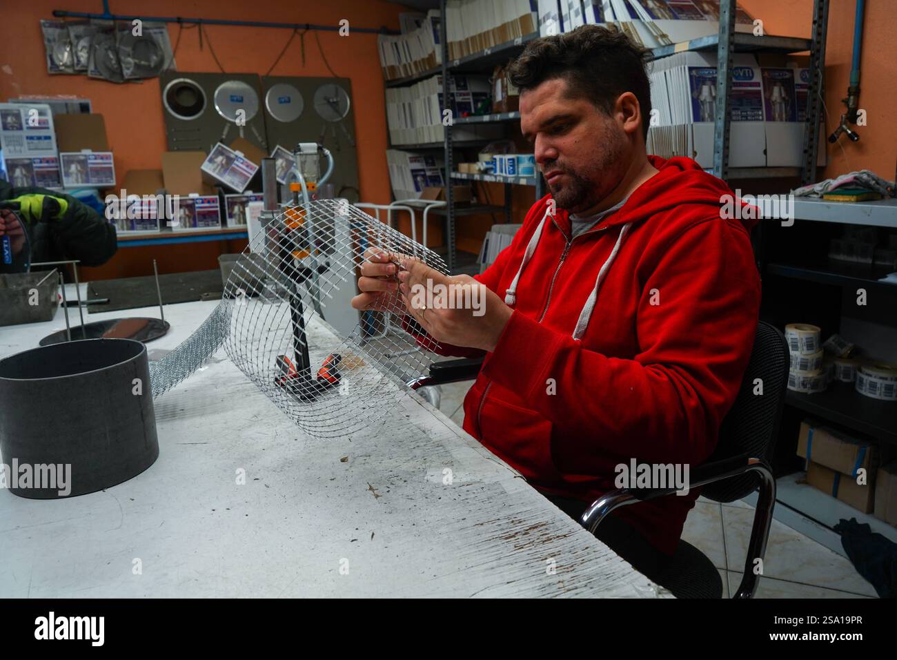 Disabled worker working in the shaping and packaging workshop. Shaping ...