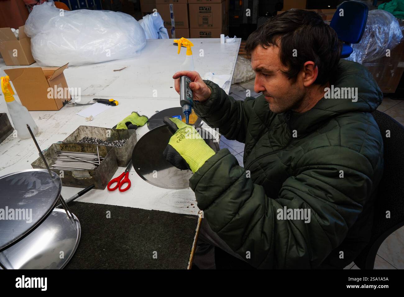 Disabled worker working in the shaping and packaging workshop. Assembly ...