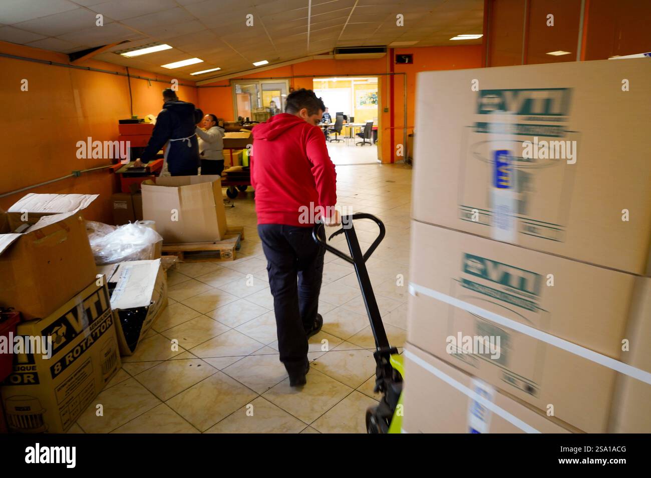 Disabled worker working in the shaping and packaging workshop ...